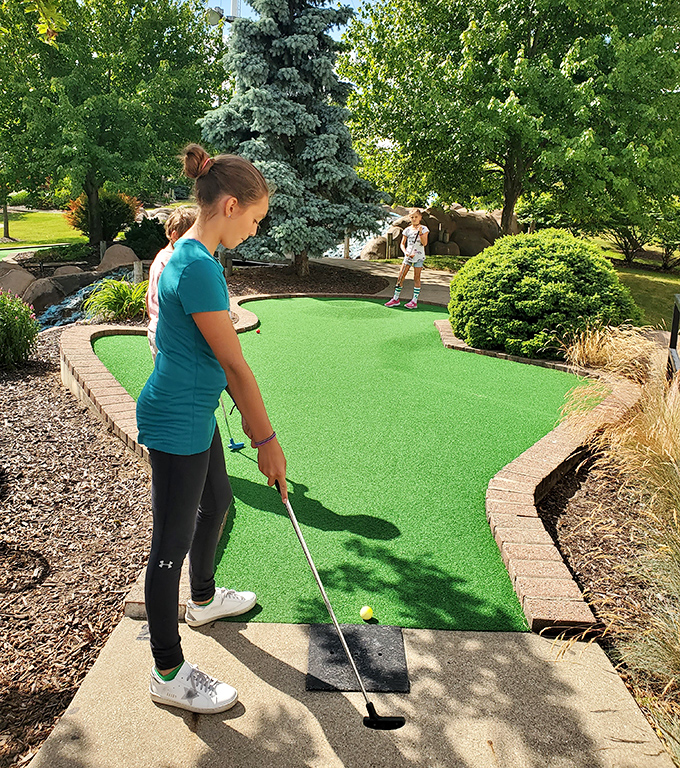 Mini golf: Concentration etched on young faces as they tackle the windmill hole, calculating angles with more precision than they ever show in math class.