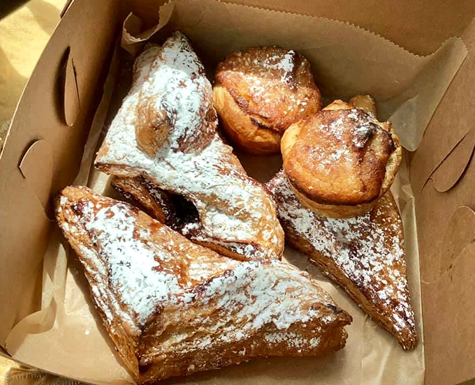 Pastries lined up like edible soldiers, each one flaky enough to create a personal snowstorm of buttery crumbs on your shirt.