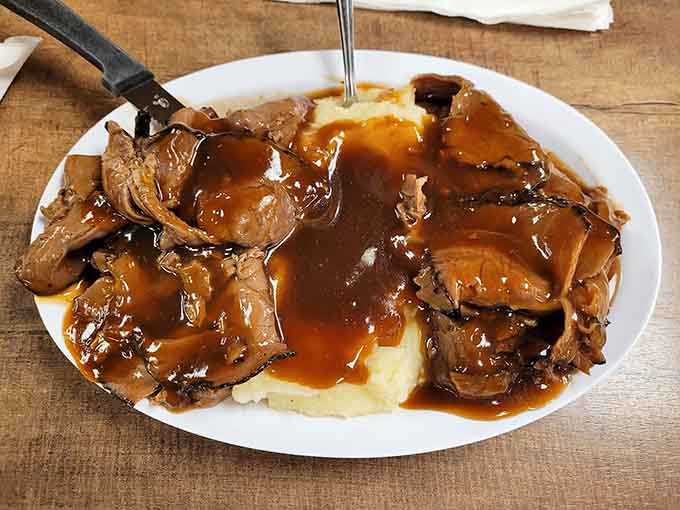 Slow-cooked roast beef drowning in rich brown gravy over creamy mashed potatoes is comfort food that could solve all your problems, or at least make you forget them.