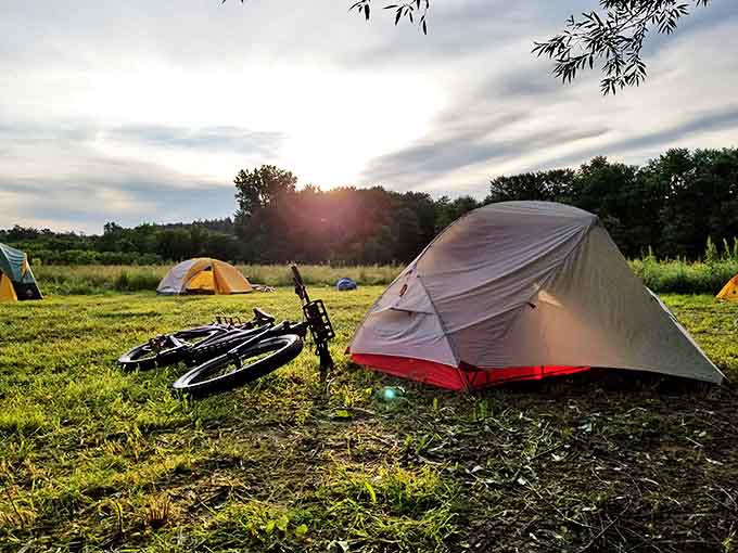 Campground: As twilight approaches, tents and bicycles create a tranquil basecamp where adventurers rest before tomorrow's journey through Wisconsin's breathtaking backcountry.