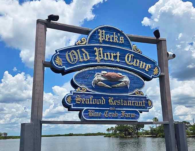 Peck's Old Port Cove welcomes hungry travelers with its distinctive sign promising fresh seafood and waterfront views worth the drive.