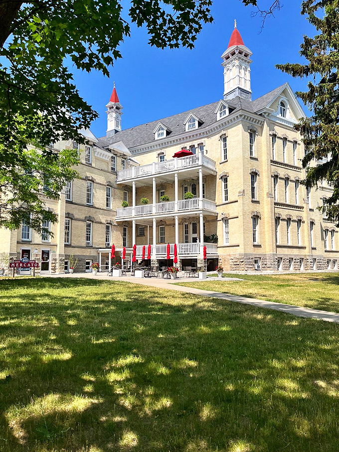 Yellow brick buildings with distinctive red-capped towers stand as monuments to Victorian architecture and innovative approaches to mental healthcare.
