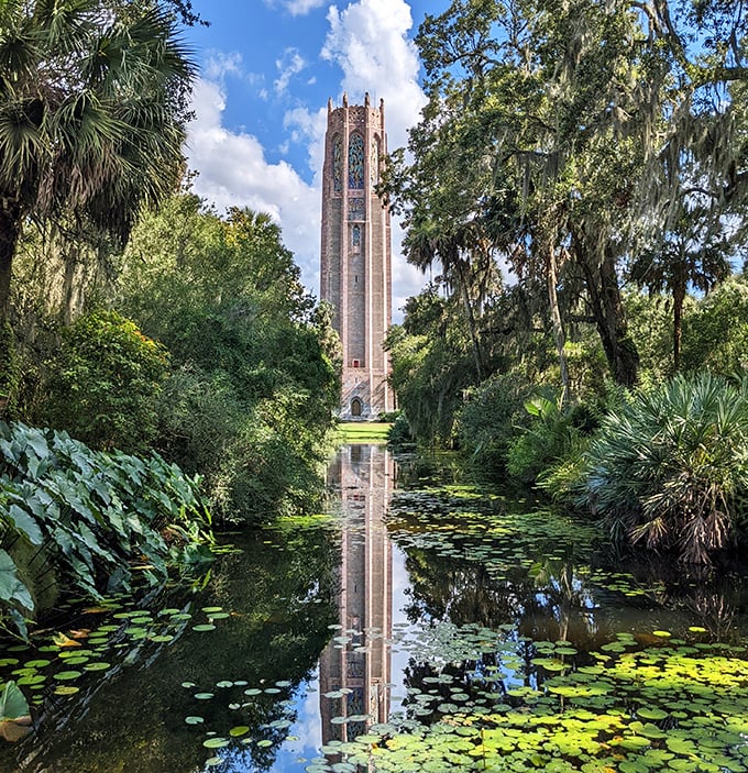 Bok Tower reflects perfectly in the lily pad-dotted pool, creating a double vision of beauty that captures the garden's serene magic.