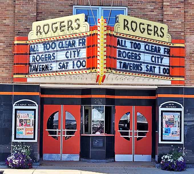 The Rogers Theater's vibrant marquee adds a splash of color to the street, preserving the charm of classic small-town entertainment.