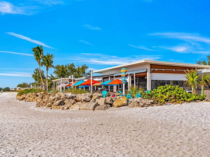 Sunset central! Colorful umbrellas and string lights transform The Beach House into a magical dining destination as day turns to evening.