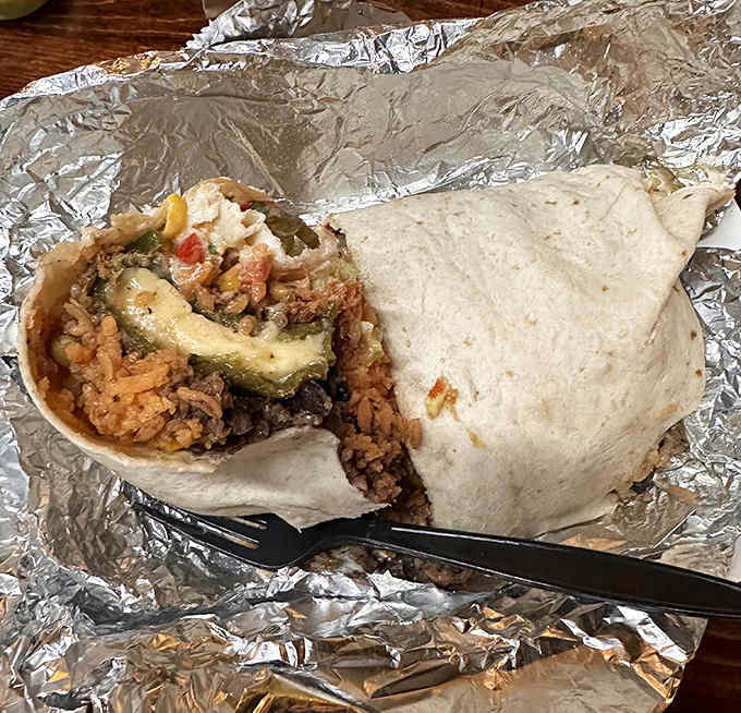 The burrito at Maya is architectural marvel wrapped in foil, revealing a cross-section of colors and textures that would make a geologist jealous.