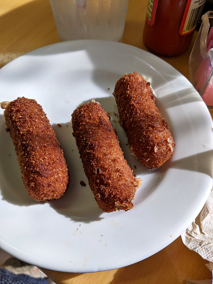 Crispy on the outside, creamy on the inside – these golden cylinders disappear from plates faster than Florida sunshine after a storm.