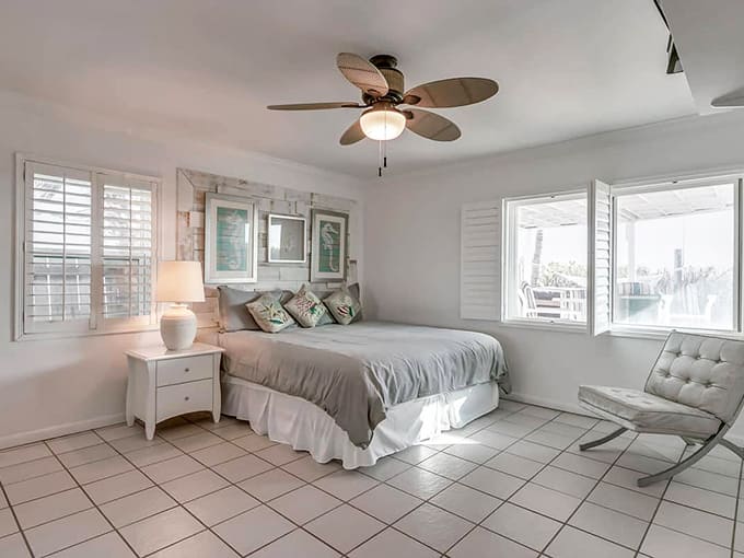 The master bedroom's serene palette and ocean views create a sleeping situation that might make leaving bed genuinely difficult.
