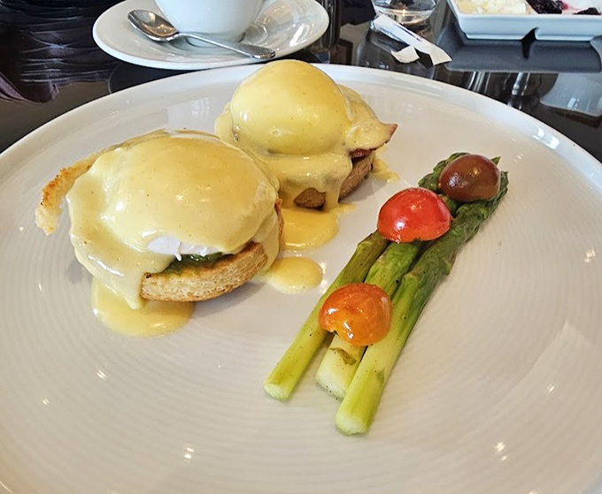 Eggs Benedict so perfectly executed, the hollandaise sauce cascades like a yellow waterfall of breakfast dreams.