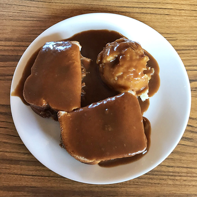 The hot beef sandwich &ndash; tender meat smothered in rich gravy that pools around mashed potatoes. Midwestern comfort on a plate.