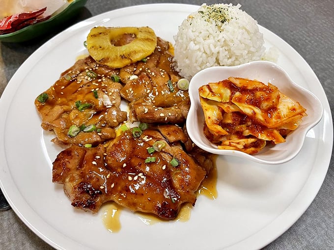Huli Huli chicken glistens with its signature glaze, the pineapple adding tropical sweetness to the perfectly grilled meat.