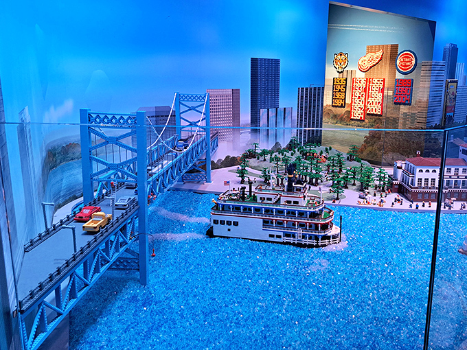 This meticulously crafted LEGO bridge spans a sea of blue bricks, connecting miniature worlds with engineering precision.