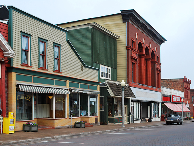 Pastel-painted storefronts and brick facades create a living postcard of small-town America, preserved like a perfectly staged movie set.