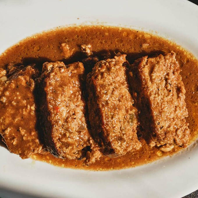 Swimming in rich gravy, these meatloaf slices aren't just food &ndash; they're edible hugs that grandmother would approve of.