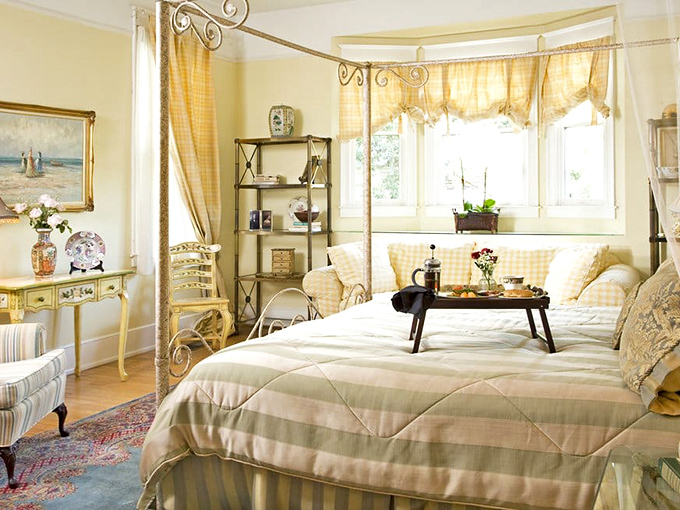 Soft yellows and elegant furnishings create a sunny sanctuary in the Mizell Suite, where Victorian charm meets modern comfort.