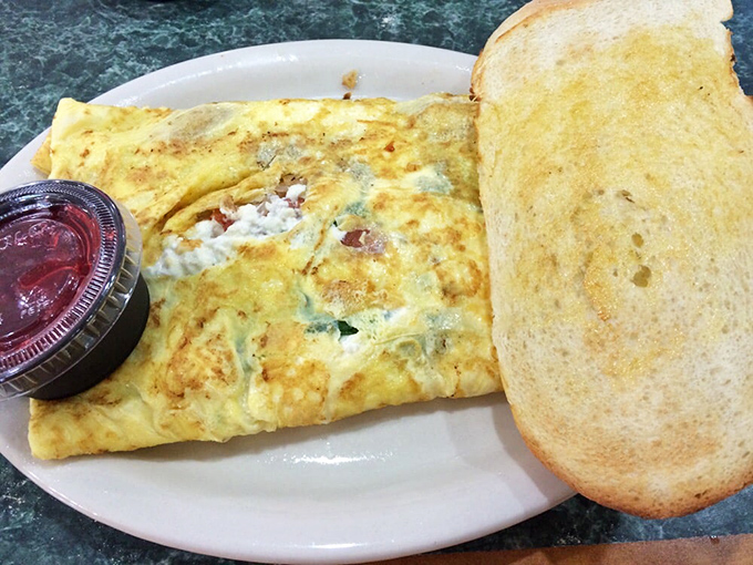 Their omelets arrive like fluffy yellow pillows stuffed with enough fillings to stock a small grocery store.