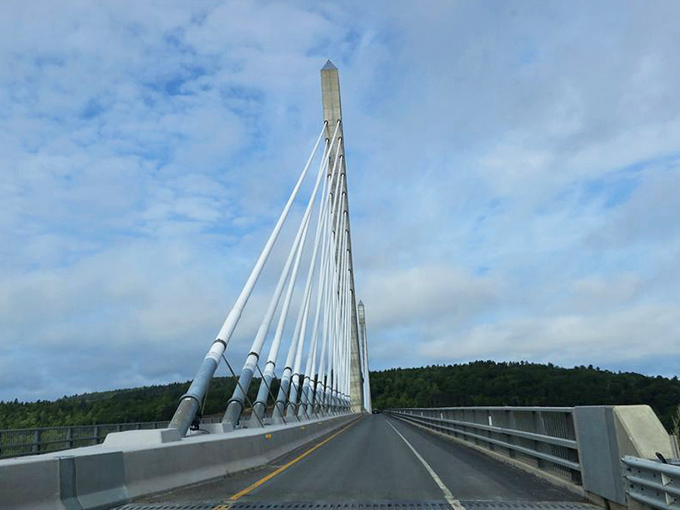 The bridge's roadway stretches into the distance, offering drivers a dramatic passage over the Penobscot River.