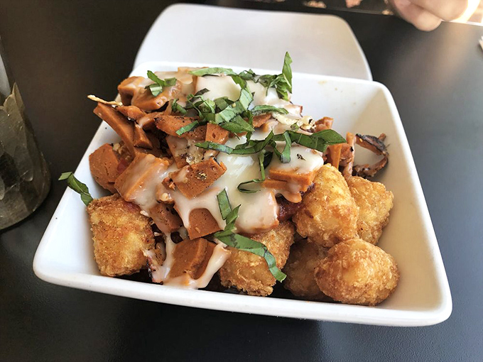 Pizza meets tater tots in this genius hybrid dish &ndash; crispy potato nuggets topped with marinara, melty vegan cheese, and herbs that'll make you question why this isn't everywhere.