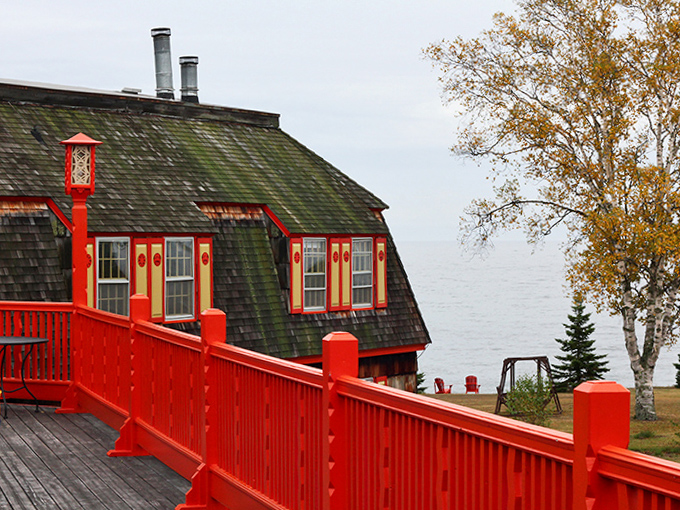 The vibrant red deck railing frames Lake Superior views, creating perfect sunset-watching perches after days of shoreline exploration.