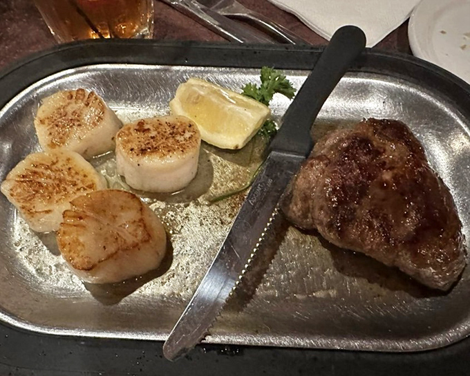 Land meets sea in perfect harmony &ndash; a tender steak alongside scallops seared to golden perfection, like ocean candy for grown-ups.