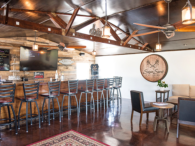 Rustic elegance meets craft spirits at Sugar Sand Distillery, where wooden beams and warm lighting create the perfect tasting atmosphere.