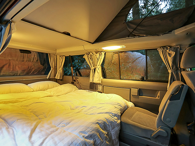 Ingenious German engineering transforms this compact space into a cozy bedroom under the stars &ndash; van life luxury at its finest.