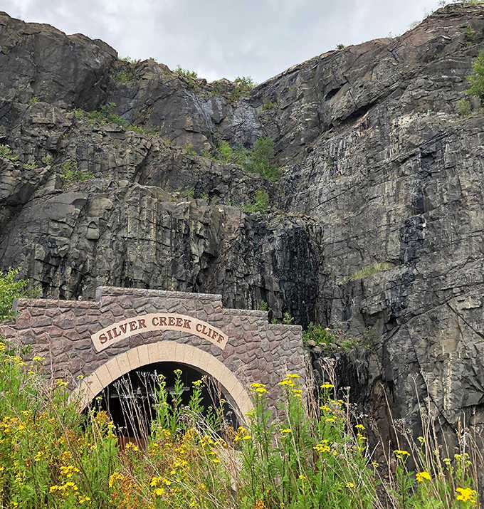 The weathered sign above the tunnel entrance has welcomed millions of travelers, standing as a silent sentinel between Lake Superior and the forested hills.