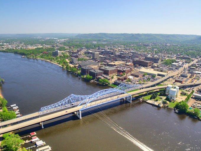 Engineering marvel meets natural wonder as the train crosses the Mississippi at La Crosse, connecting Wisconsin to Minnesota.