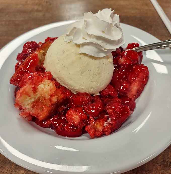 Strawberry shortcake with fresh berries, whipped cream, and ice cream proves that dessert isn't just an afterthought here, it's a full-blown production.