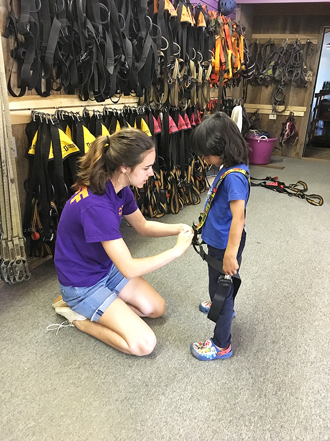 The future daredevil gets fitted for adventure. That look of concentration says it all &ndash; serious fun requires serious safety equipment.