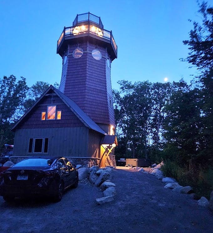 As twilight falls, the lighthouse transforms into a beacon of warmth, its windows glowing like fireflies in the Minnesota dusk.