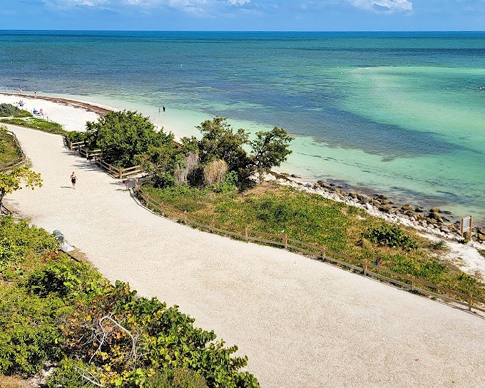 Calusa Beach's wooden pathway leads through sea grasses to paradise, just steps from parking to perfection.