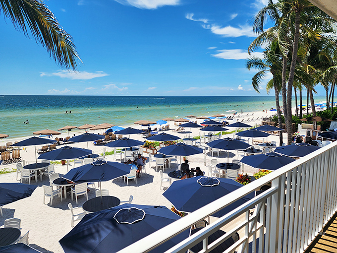Elegance meets beach casual. The Turtle Club's crisp white tables and blue umbrellas create an upscale dining experience right on Naples' sandy shore.