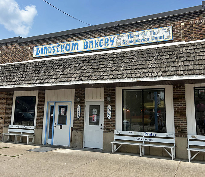 A blue sign that promises sweet treasures! Lindstrom Bakery's modest exterior hides one of Minnesota's most unique donut experiences.