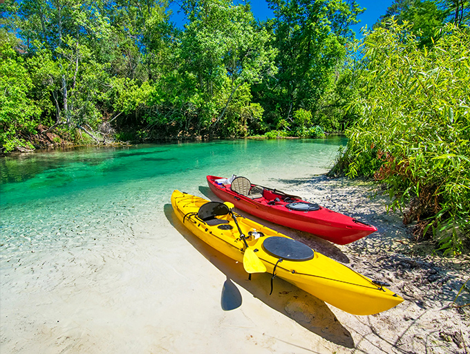 Vibrant kayaks rest on Weeki Wachee's pristine shoreline, ready to take adventurers down one of Florida's most beautiful spring-fed rivers.