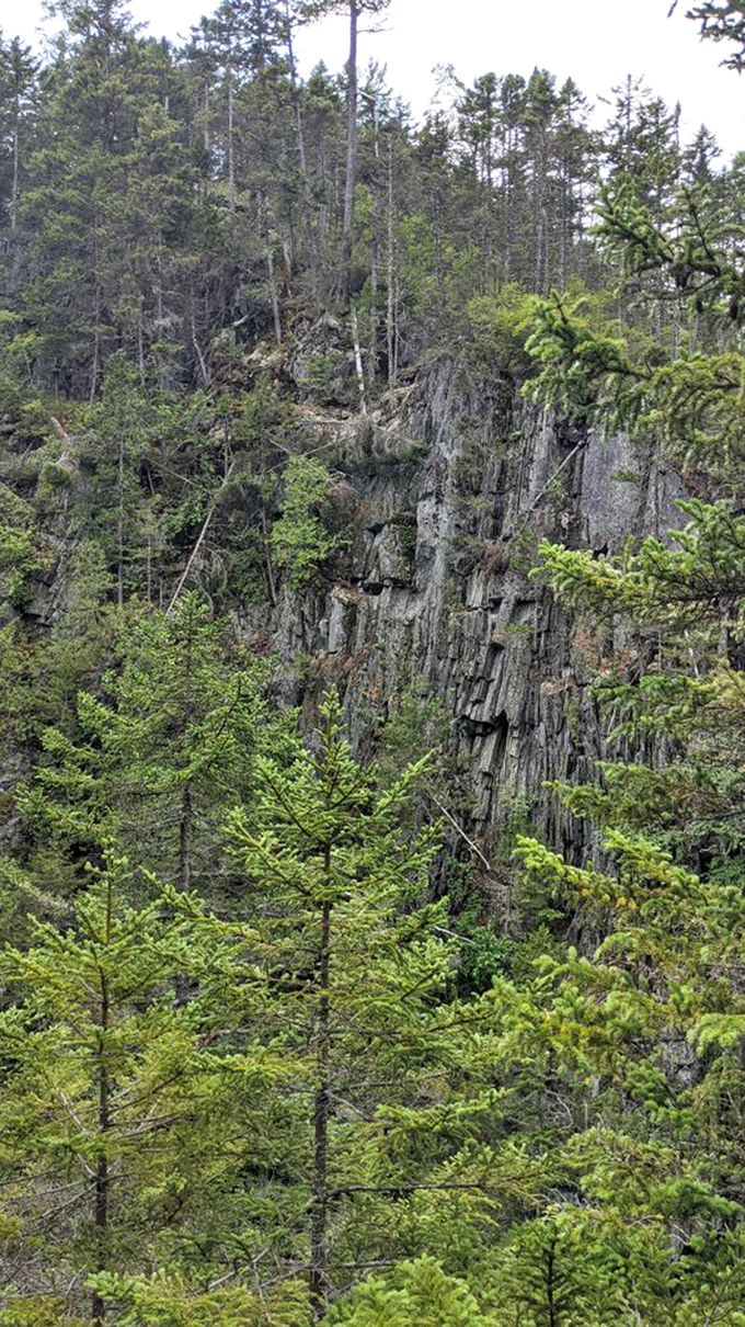 Towering slate formations stand like ancient sentinels, their layered history exposed by millennia of patient erosion and geological drama.