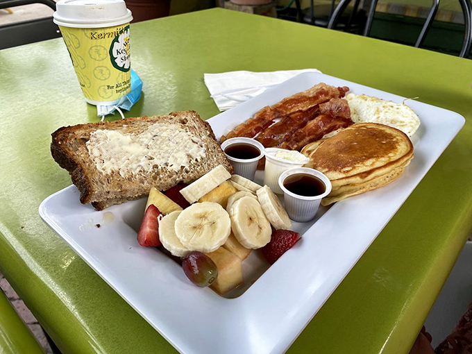 Morning fuel, Florida-style &ndash; where pancakes, eggs, and bacon meet fresh fruit in a sunrise symphony on a plate.