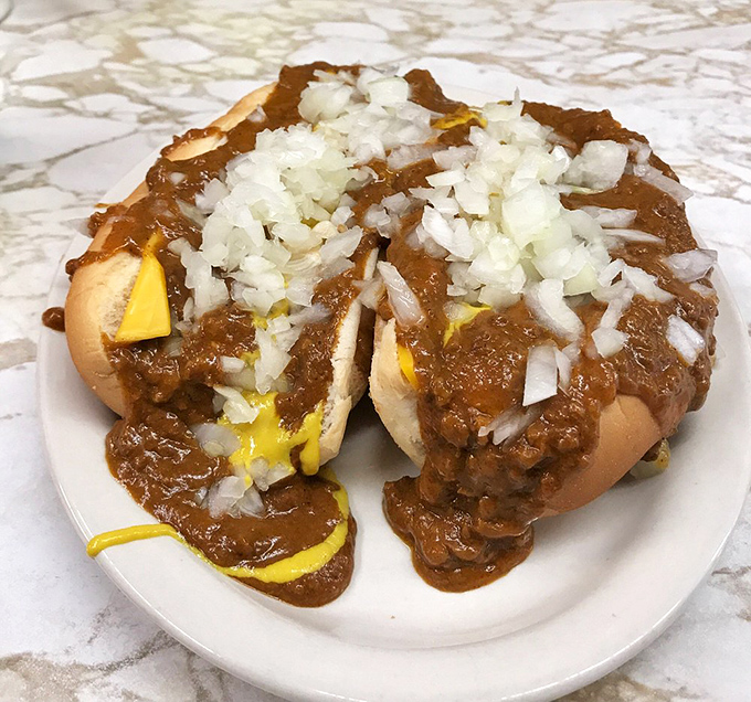 Chili, mustard, and onions create the holy trinity of Coney dog toppings, a Detroit tradition that tastes even better at 3 AM.