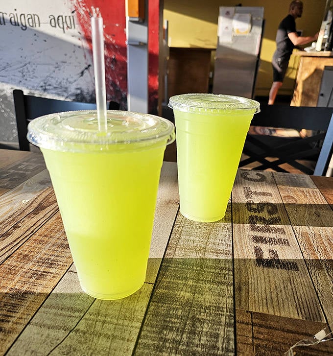 Drinks: Vibrant lime-green aguas frescas offer a refreshing counterpoint to the rich flavors, like a tropical vacation in a cup.