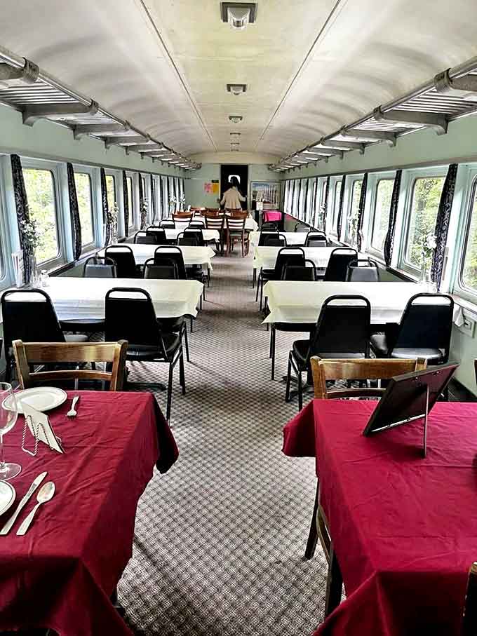 Elegant dining awaits in this first-class car, where white tablecloths and vintage ambiance transform a train ride into a moving feast for all senses.