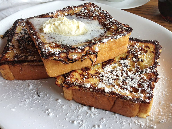 French toast that makes you question all other breakfast choices &ndash; crisp edges, custardy centers, and a snowfall of powdered sugar.