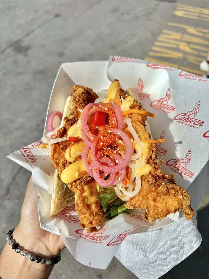 The Banh Mi sandwich merges Vietnamese flavors with perfectly fried chicken, creating a cross-cultural masterpiece topped with cilantro, chilis and sriracha mayo.