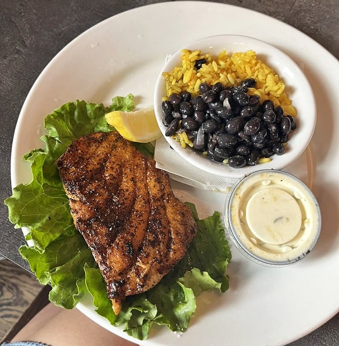 This blackened grouper doesn't just sit on the plate&mdash;it commands attention, while those black beans and yellow rice play perfect supporting roles.