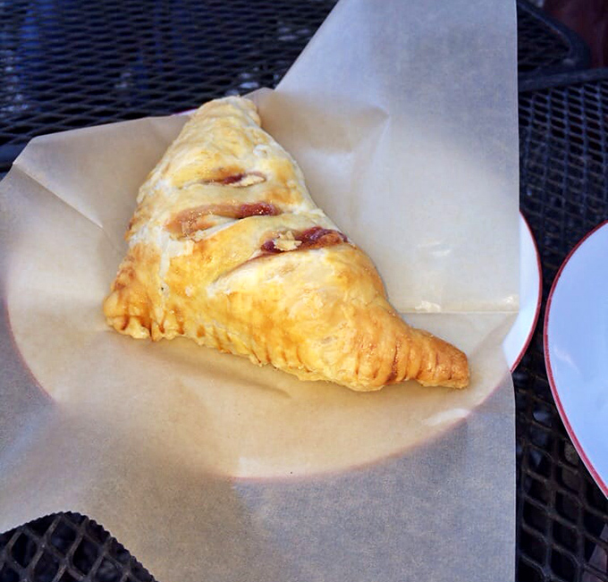 A golden-brown pastry triangle reveals hints of its sweet guava and cheese filling, like Florida sunshine wrapped in butter.