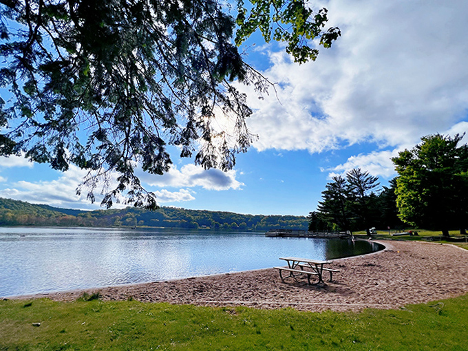 A peaceful lakeside retreat awaits just minutes from downtown, where picnic tables sit ready for families to enjoy pannukakku breakfasts with a waterfront view.