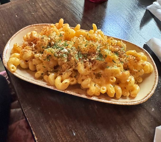 Mac and cheese transcends its humble origins here, with perfectly cooked pasta swimming in creamy cheese sauce and topped with herbed breadcrumbs.