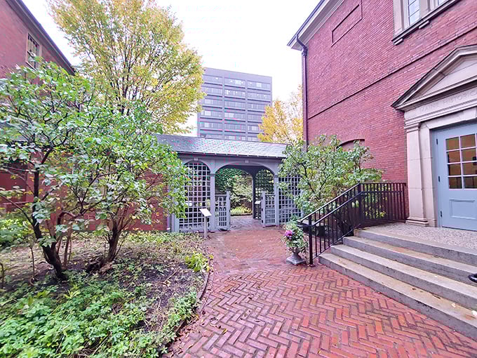 The brick pathway to the Wadsworth-Longfellow House garden creates a secret oasis where literary history and horticultural beauty merge in downtown Portland.