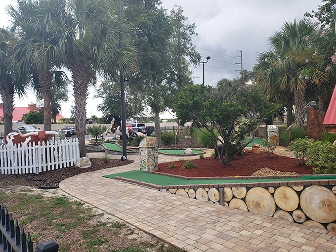 Winding paths through lush landscaping lead mini-golfers through a challenging course designed for family-friendly competition.