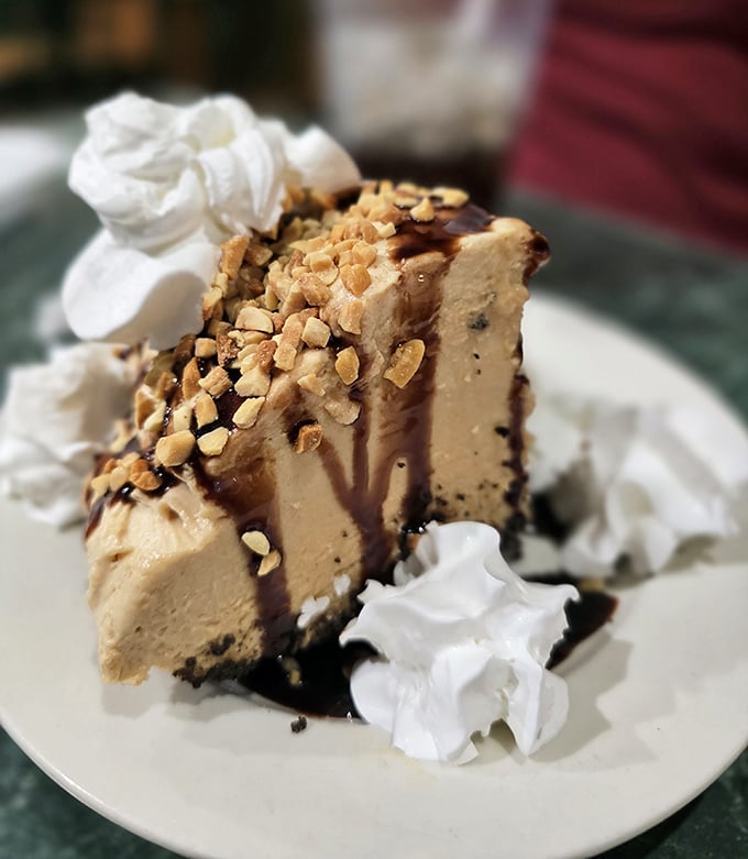 Peanut butter pie that doesn't just satisfy your sweet tooth – it throws a party for it, complete with chocolate drizzle and crunchy peanut topping.