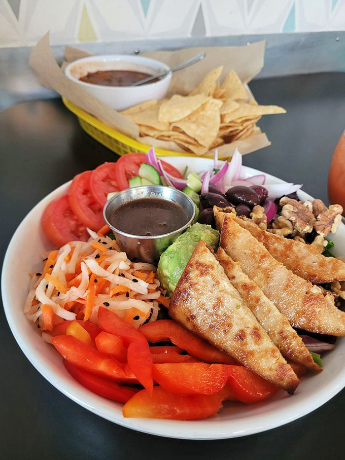 A vibrant salad bowl bursting with fresh vegetables and protein-packed additions proves that plant-based eating is anything but boring or unsatisfying.